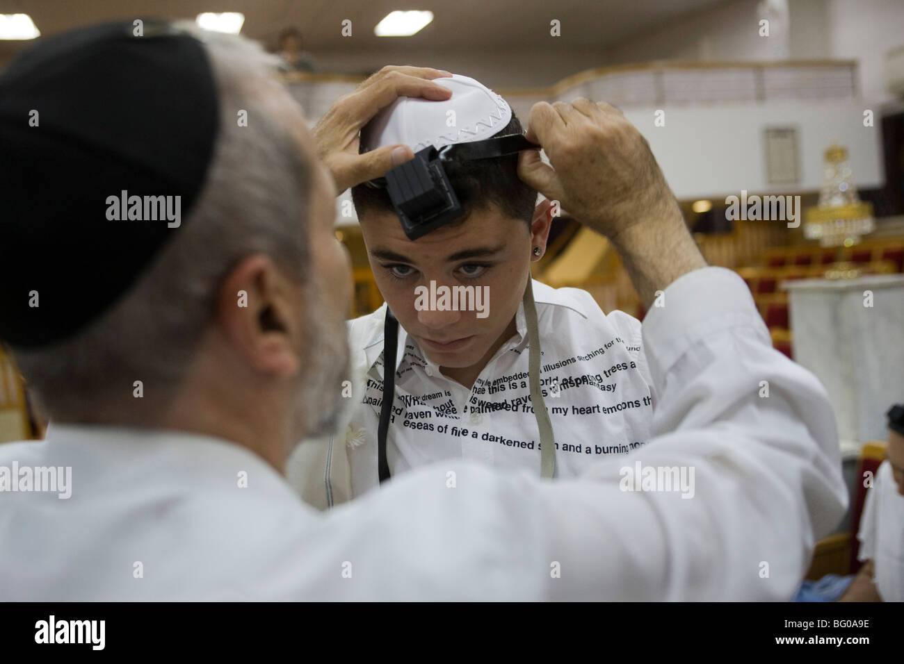Bar Mitzvah boy laying tefillin (phylacteries) during ceremony Stock ...