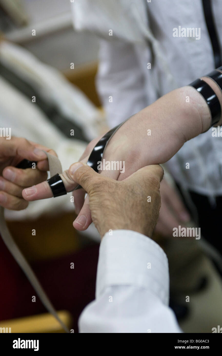 Bar Mitzvah boy laying tefillin (phylacteries) during ceremony Stock ...