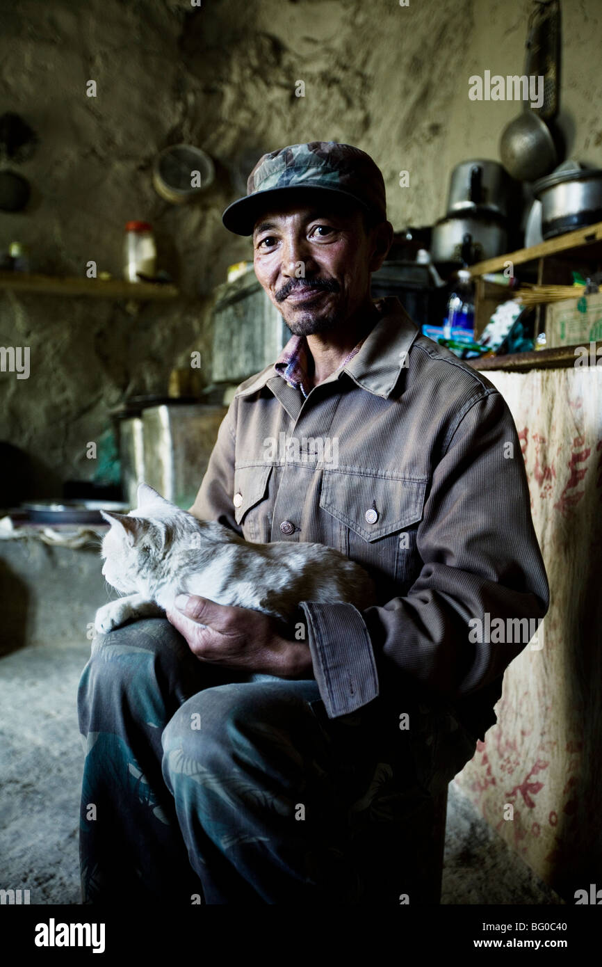 Man petting his cat in Lamayuru monastery complex in Ladakh, Indian ...