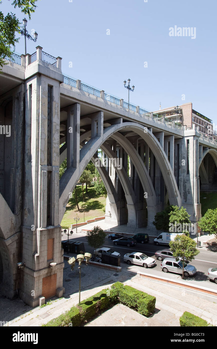 Vehicles moving under a railway bridge, Viaducto De Segovia, Madrid ...