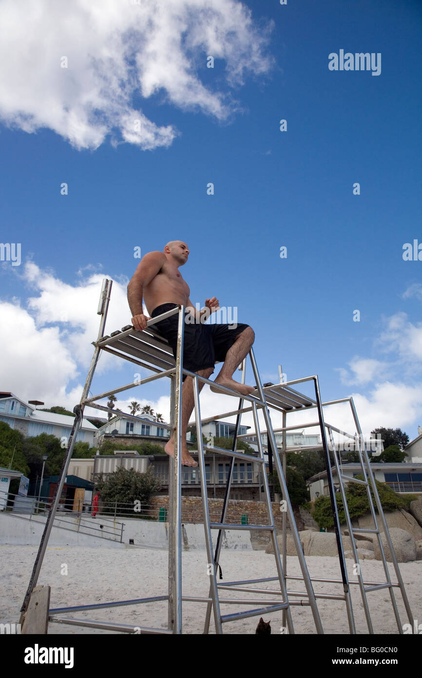 Man on Metal lifeguard frame on Clifton beach Stock Photo - Alamy