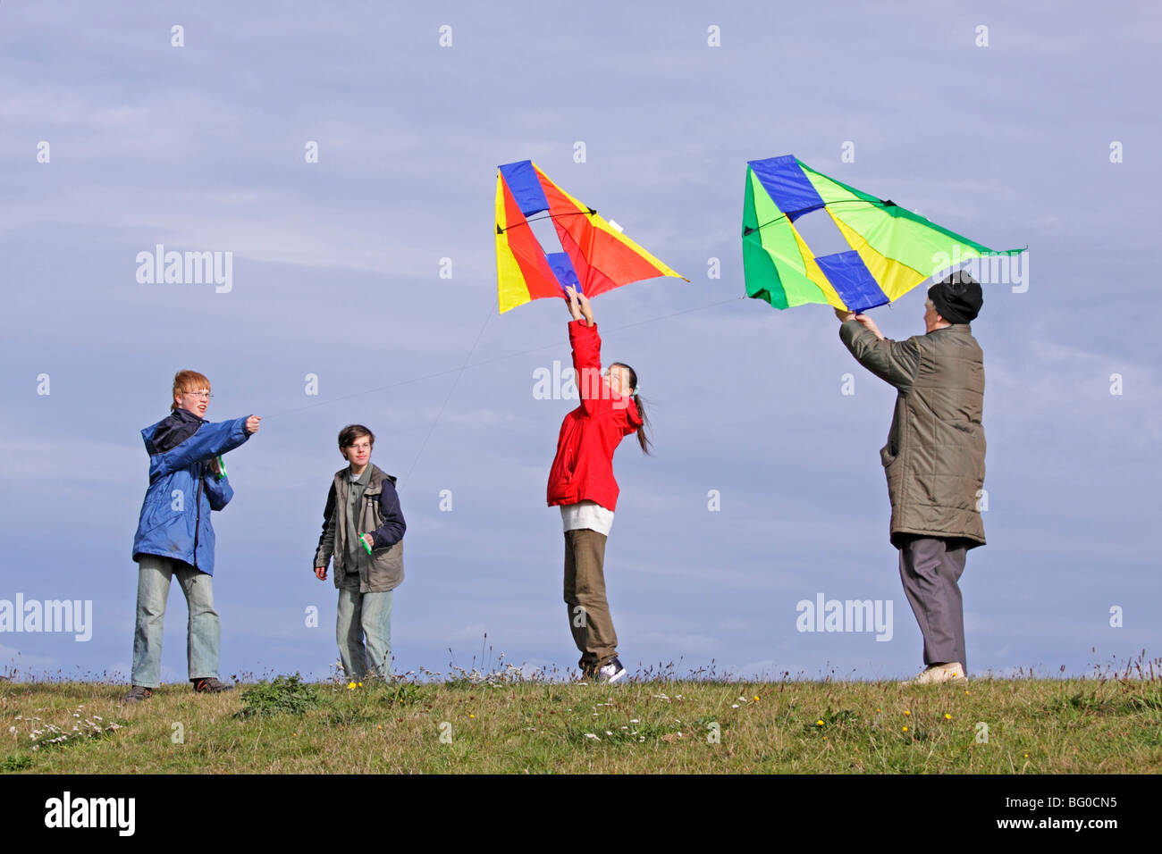 family flying kites Stock Photo - Alamy