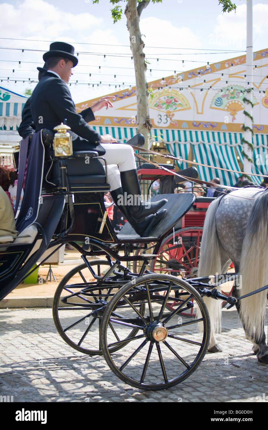 Men riding a horse cart in a fair, Seville, Andalusia, Spain Stock ...