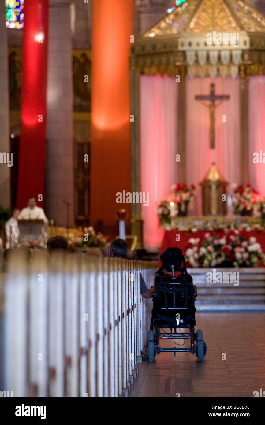 Disabled person in a wheelchair in the nave of the Roman Catholic ...
