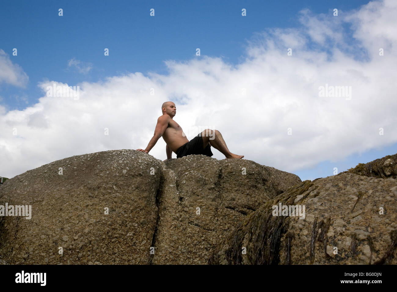 Man lying on rock Stock Photo - Alamy