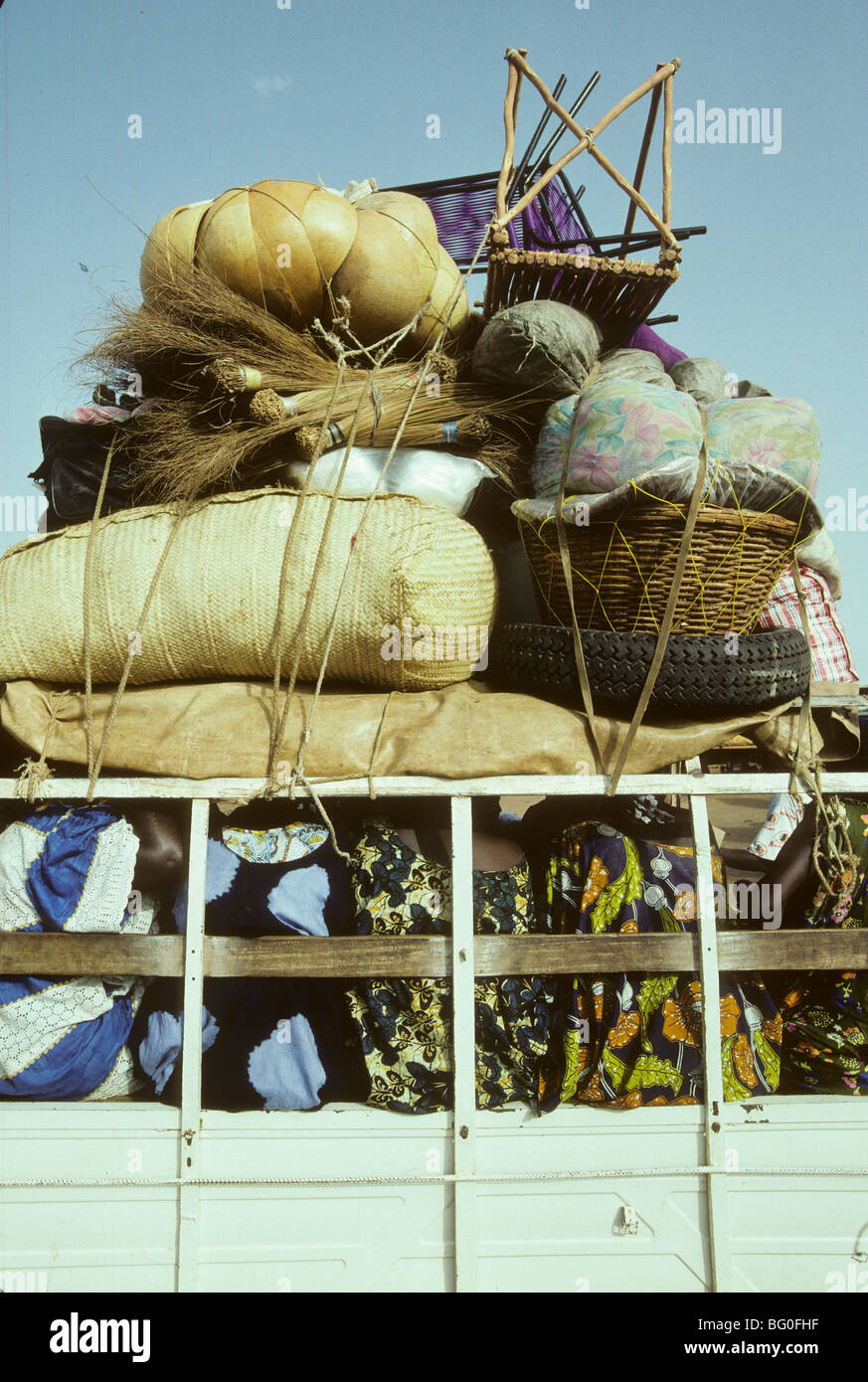 A bush taxi is loaded with passengers and goods after a day at the ...