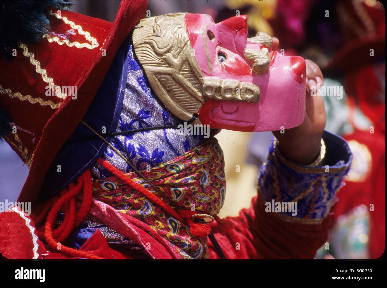 A pole flyer (Los Voladores) lifts his mask to get some air and rests ...
