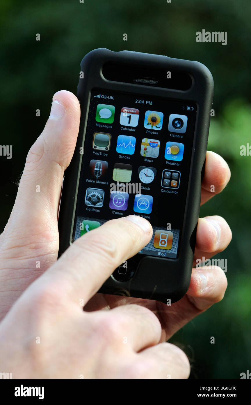 Man's hand operating a iPhone touch screen Stock Photo - Alamy