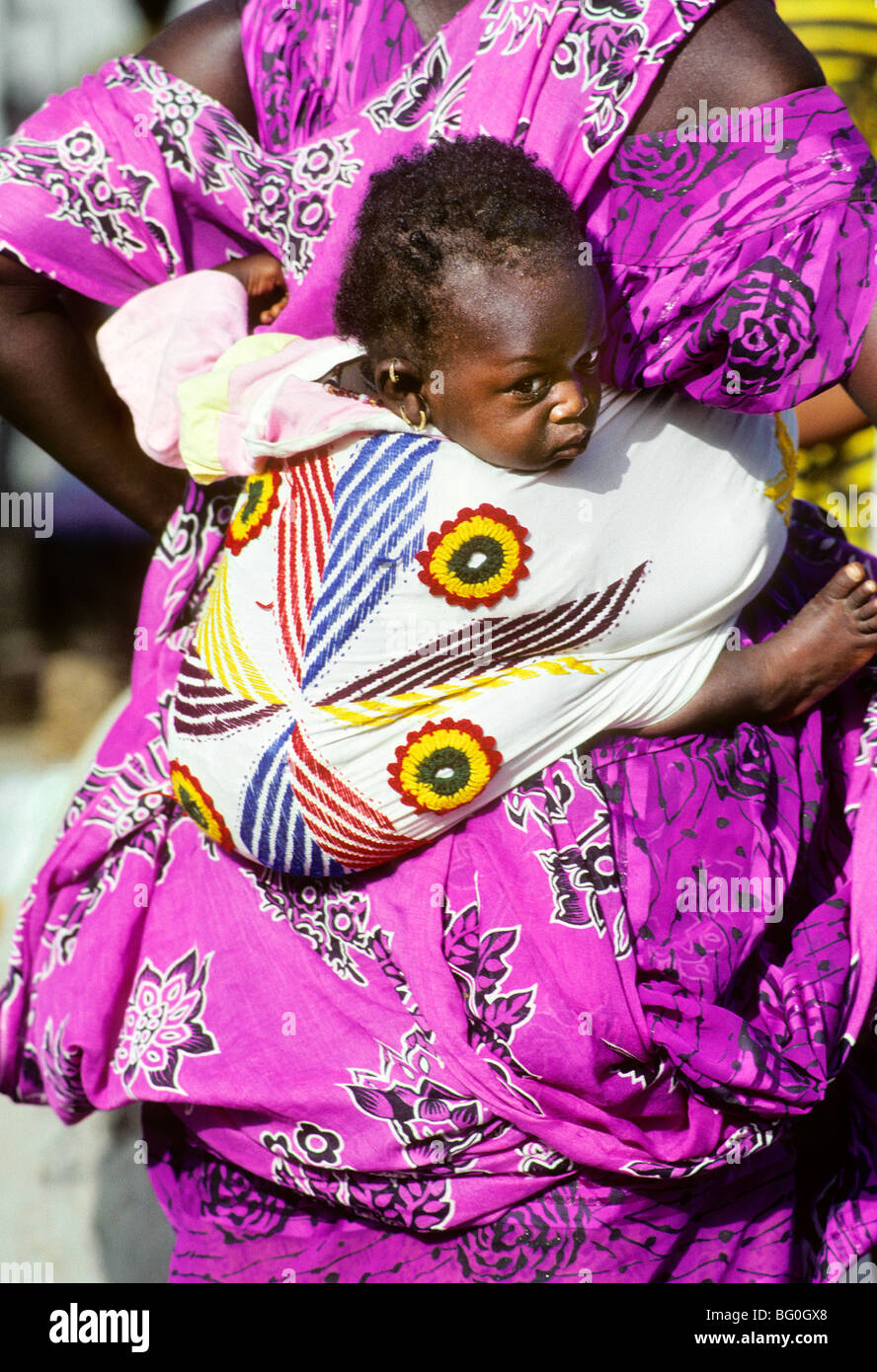 A mother carries her baby girl on her back, Segou, Mali, West Africa ...
