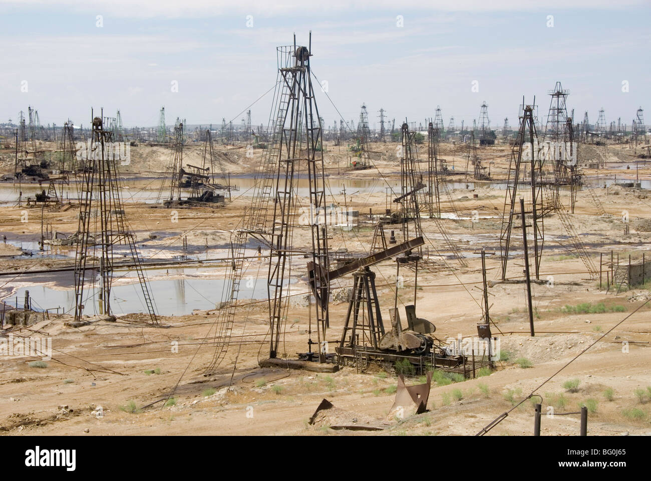 Closely spaced drilling towers and nodding donkey beam pumps, Ramana ...