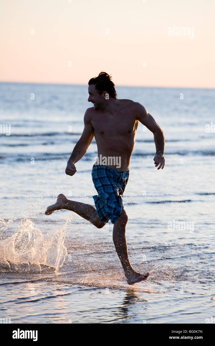 Running on the beach Stock Photo - Alamy