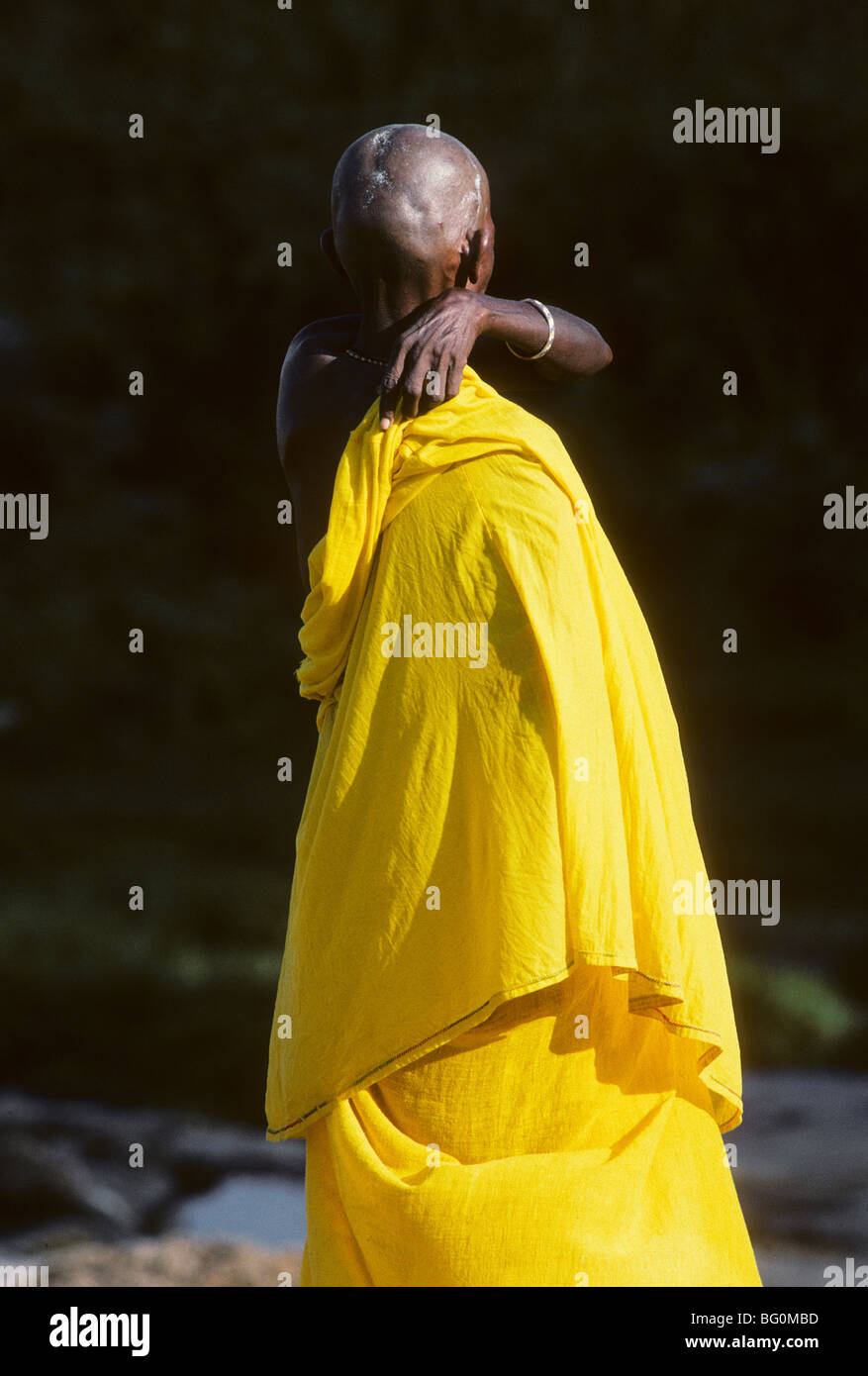 An Indian woman is putting on her sari after taking a bath, Palani ...