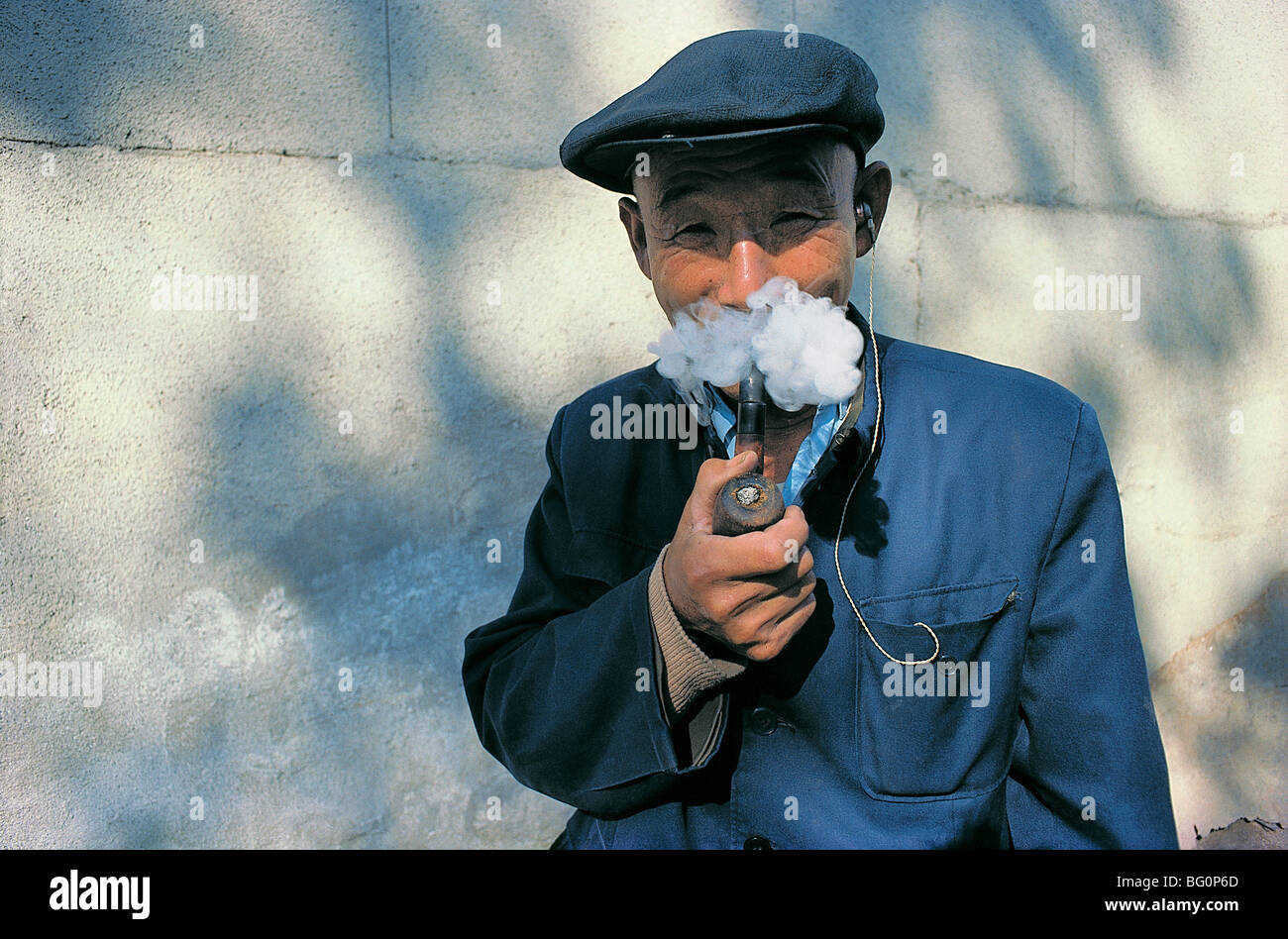 A portrait of a man smoking a pipe in Beijing, China Stock Photo - Alamy