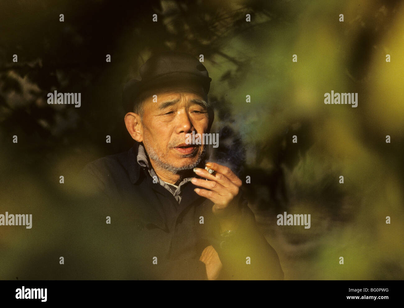 Portrait of man smoking, Beijing, China Stock Photo - Alamy