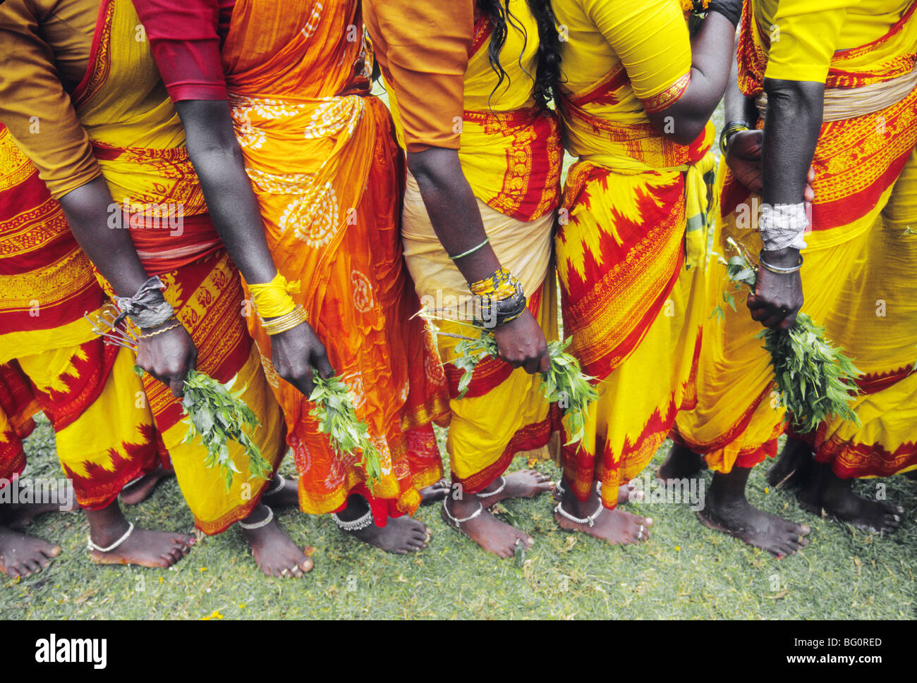 Women wait in line to participate in fire walking at a Hindu festival ...