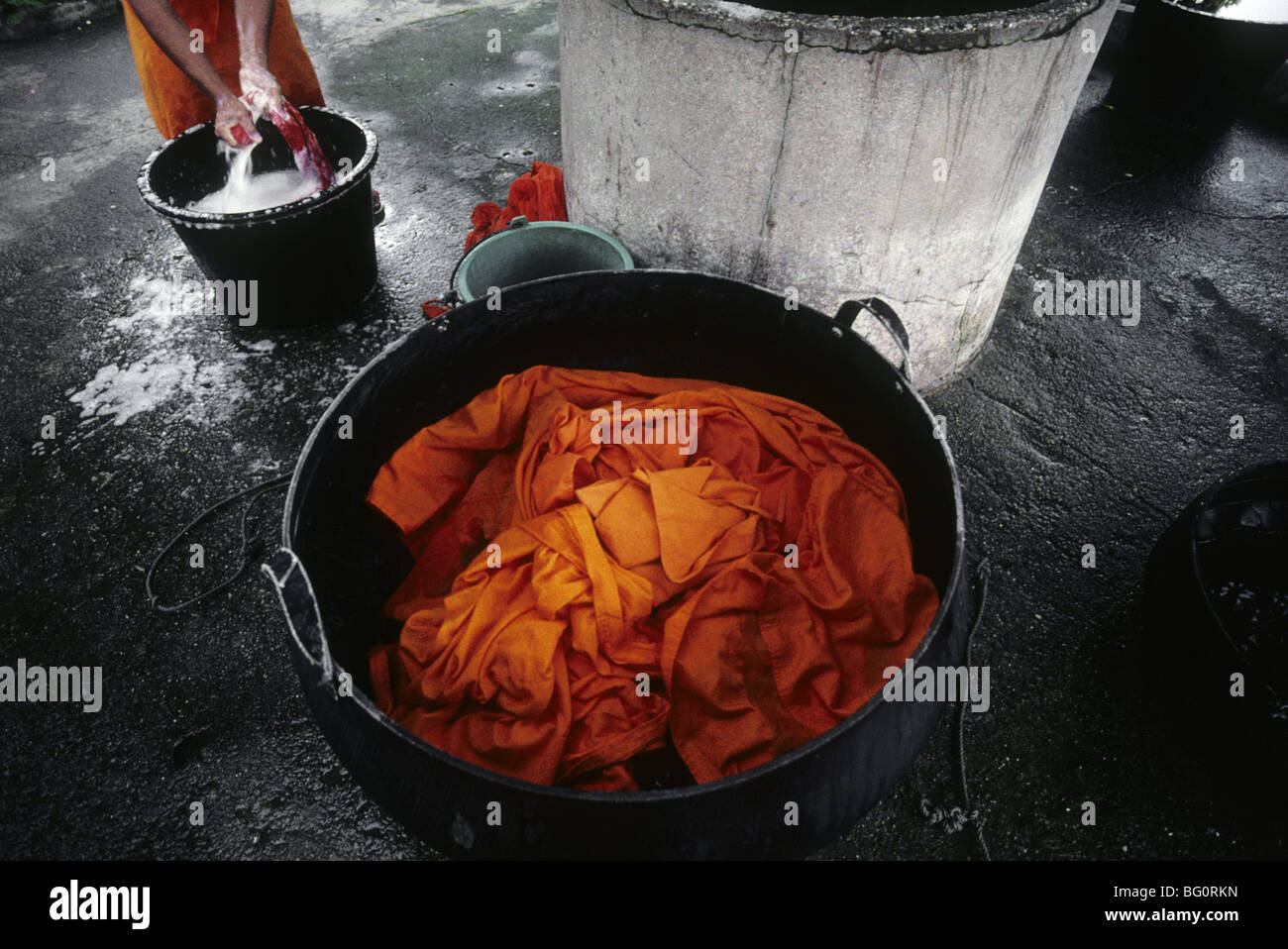 A Buddhist monk washes robes in his Temple in Chiang Mai, Thailand ...