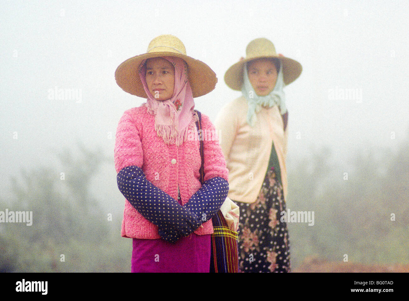 Portrait of two women in the morning fog, Menghai, Yunnan Province ...