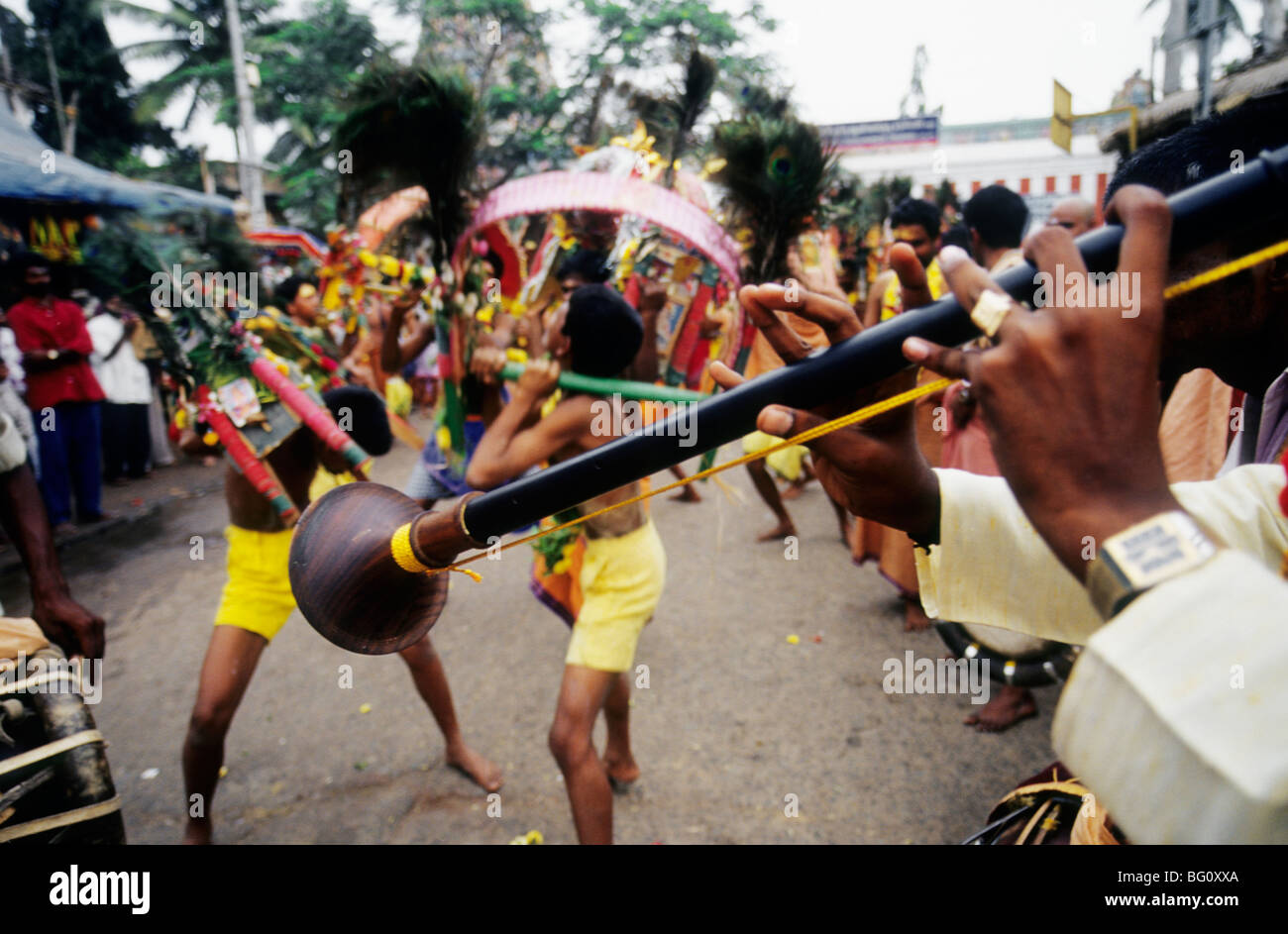 A group of devotees and pilgrims dance sing through the streets of ...