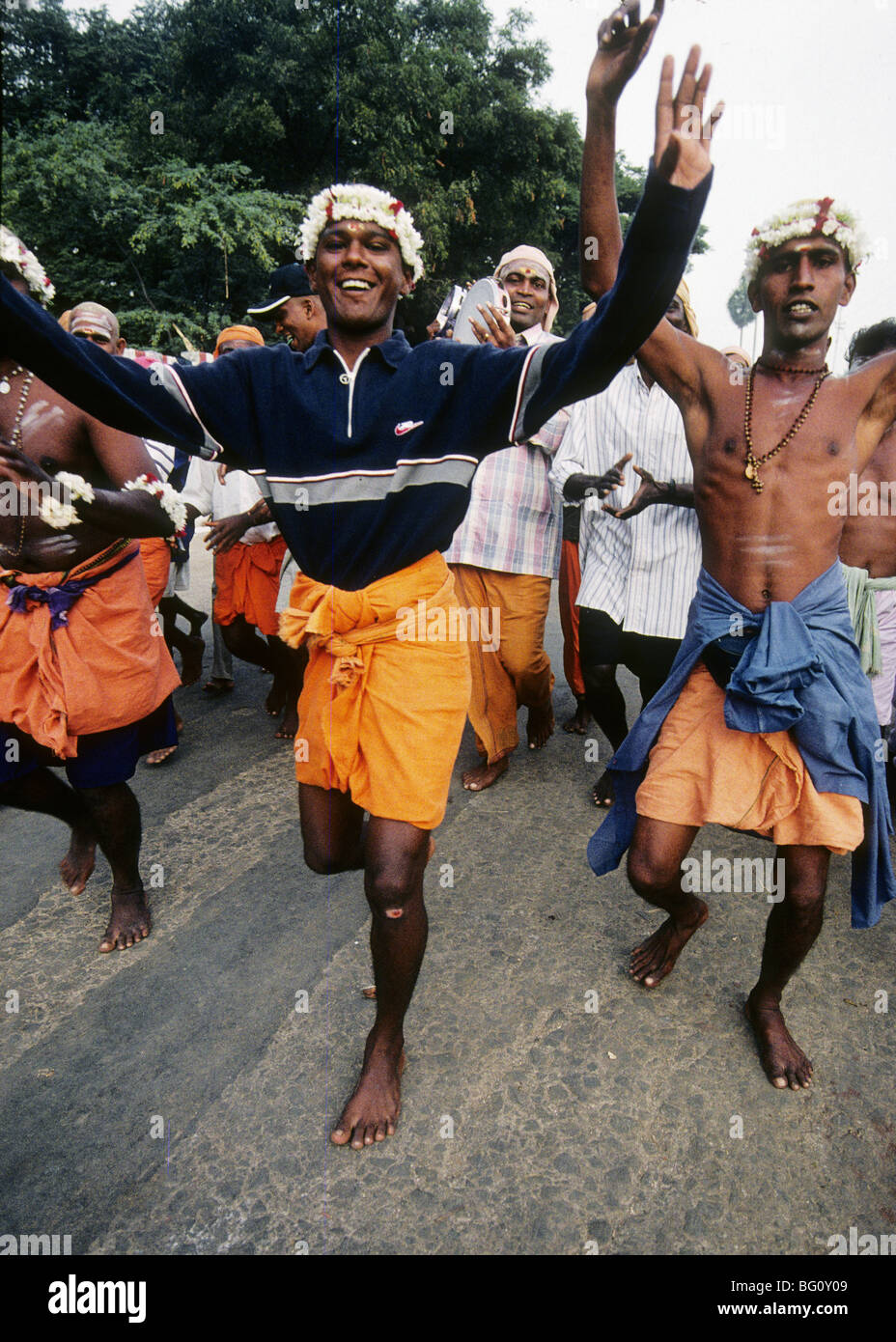 A group of devotees and pilgrims dance sing through the streets of ...