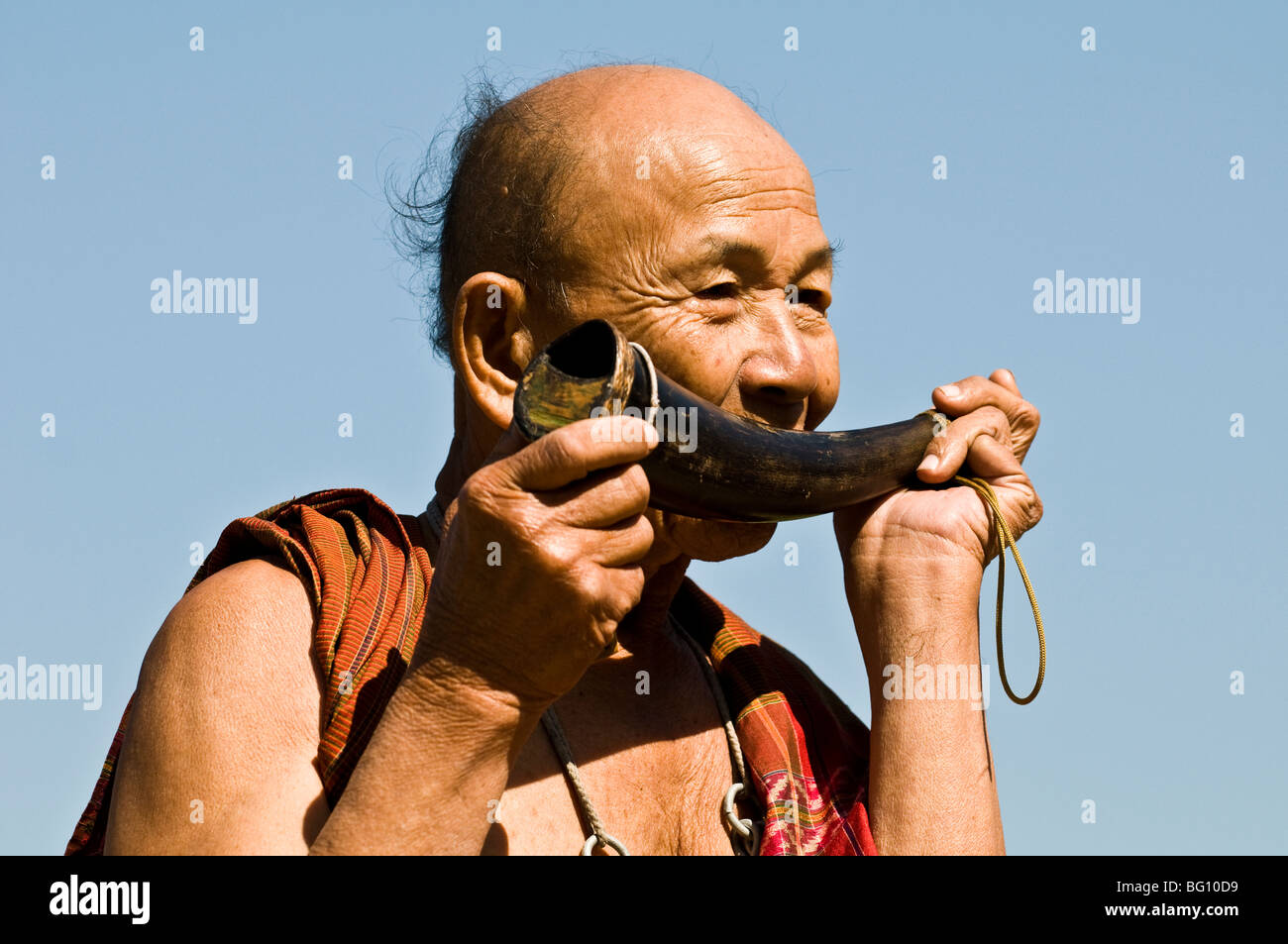 Playing a traditional musical instrument during the Elephant roundup in ...