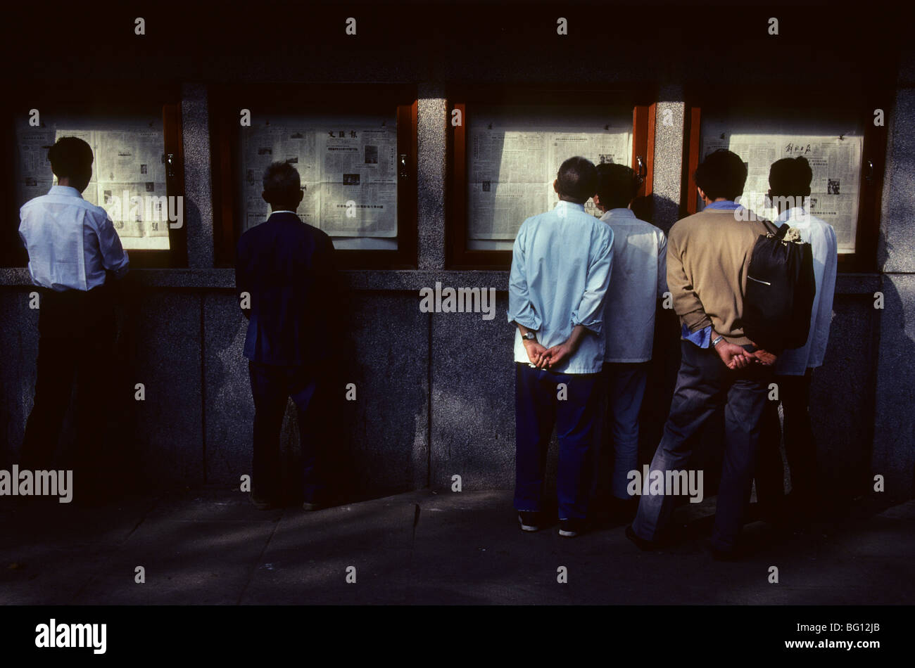 Men reading newspapers posted for the public, Beijing, China Stock ...