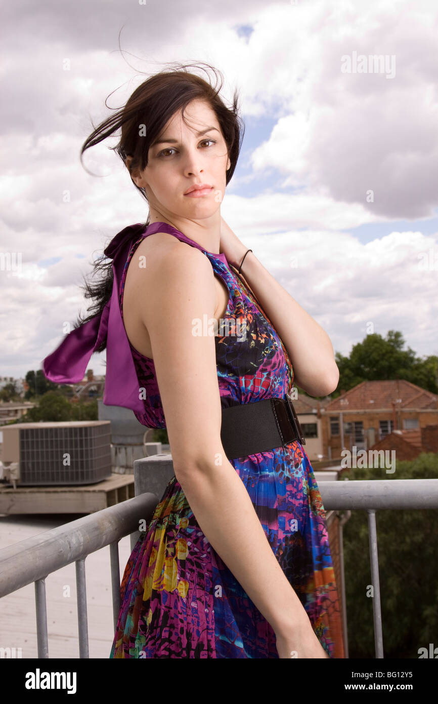 Beautiful model poses outside in a colorful dress Stock Photo - Alamy
