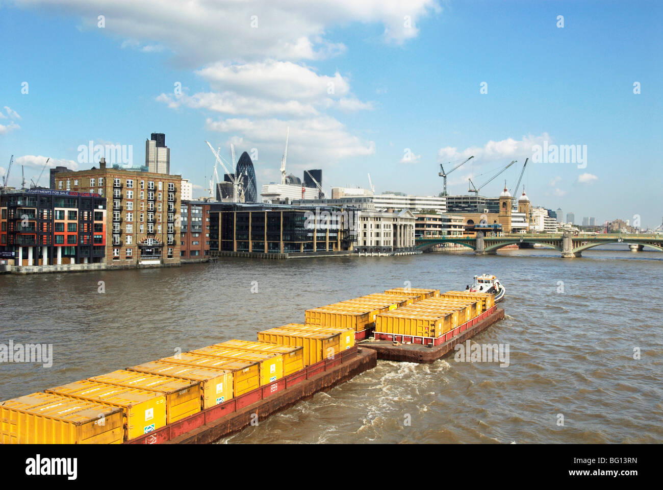 A barge with a cargo load on the Thames in Central London, UK Stock ...