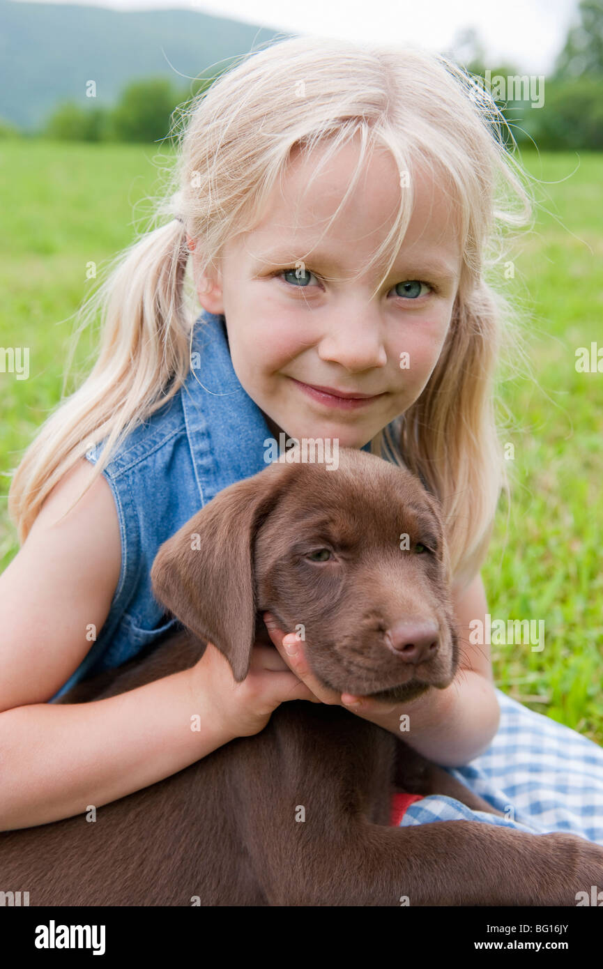 Young girl hugging her puppy Stock Photo - Alamy