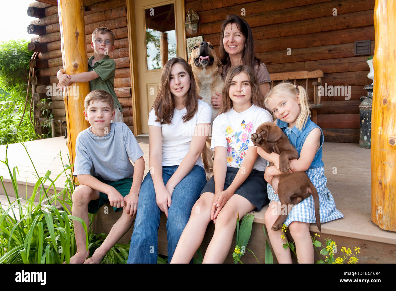 Family portrait in front of home Stock Photo - Alamy