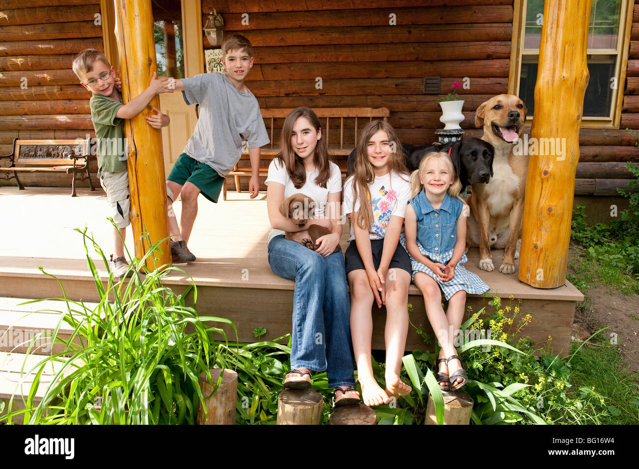 Family portrait in front of home Stock Photo - Alamy