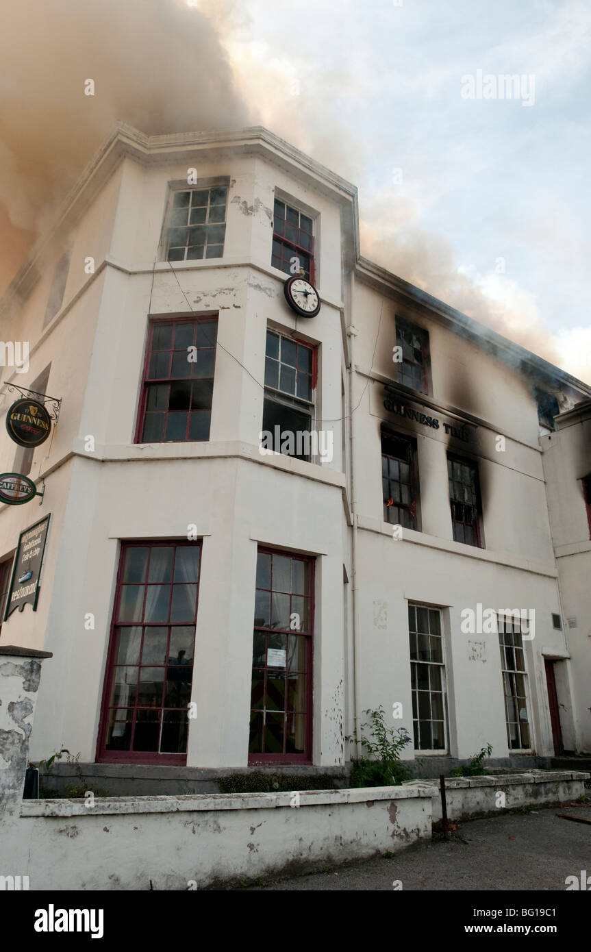 Pub on fire with smoke from windows and roof Stock Photo - Alamy