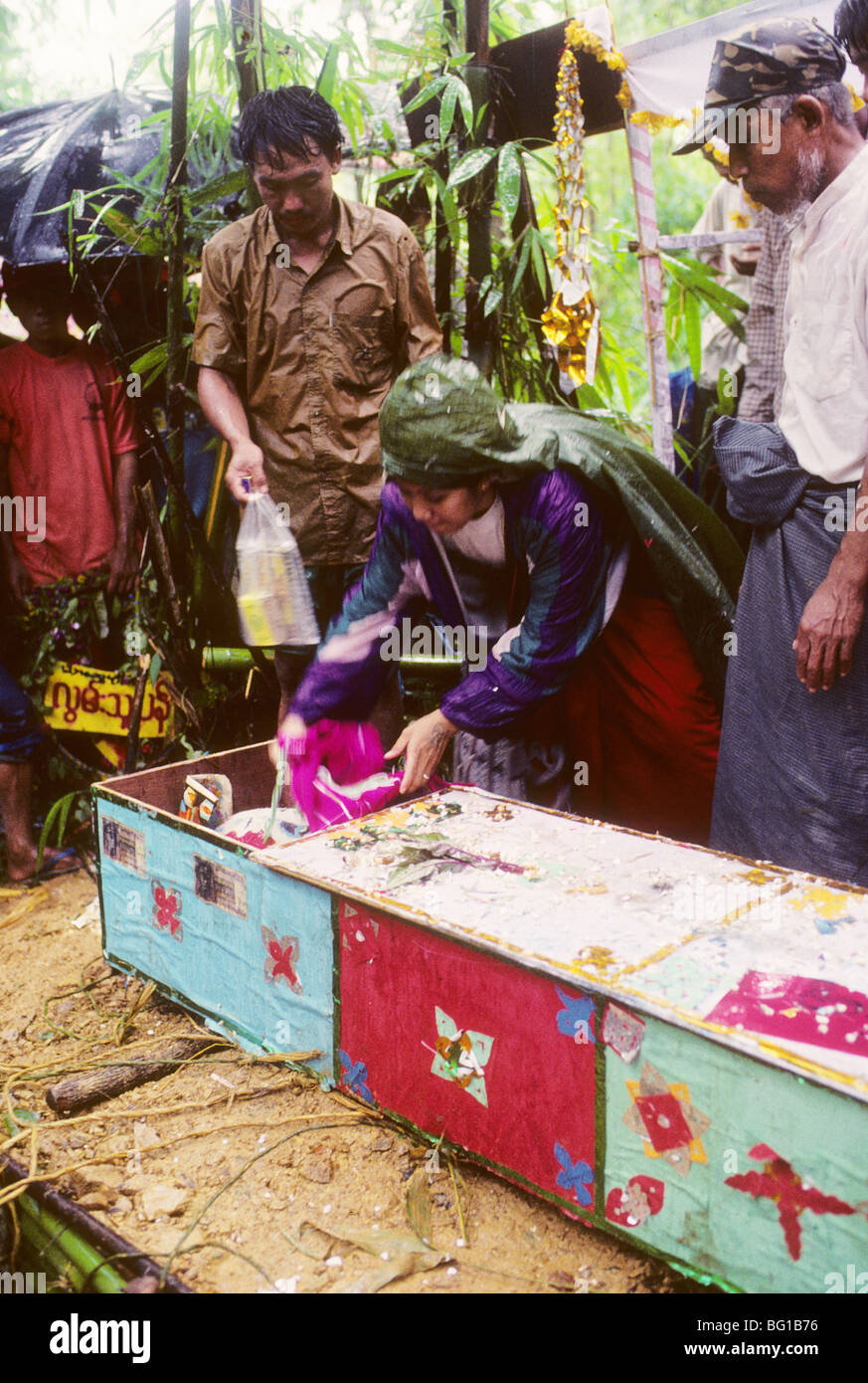As family members and mourners look on the sister of a 24 year old ...