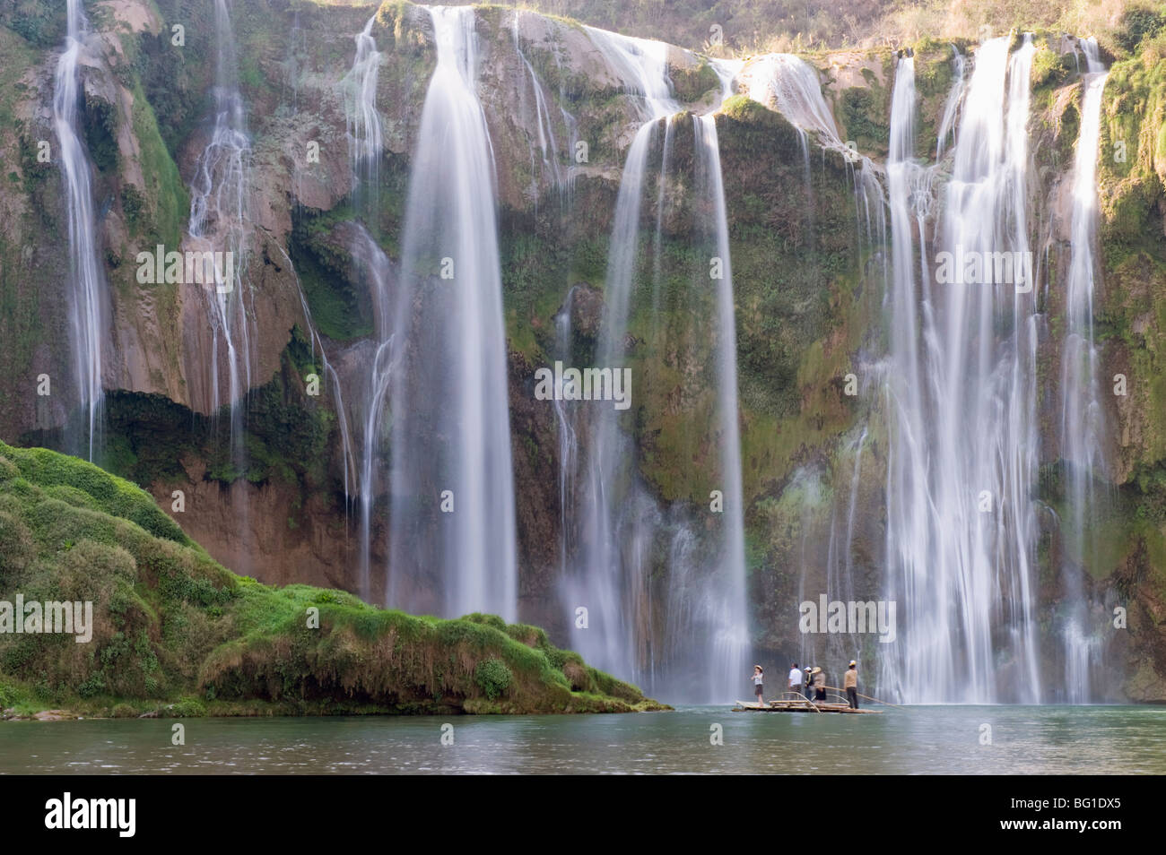 Tourists on a bamboo raft under Jiulong Falls (Nine Dragon waterfall ...