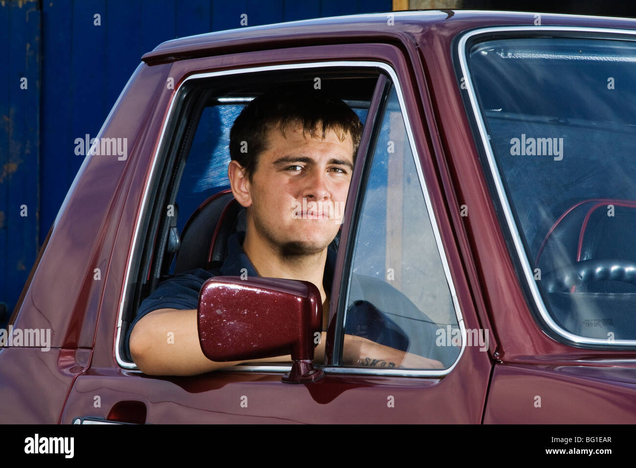 Man in car looking at camera Stock Photo - Alamy