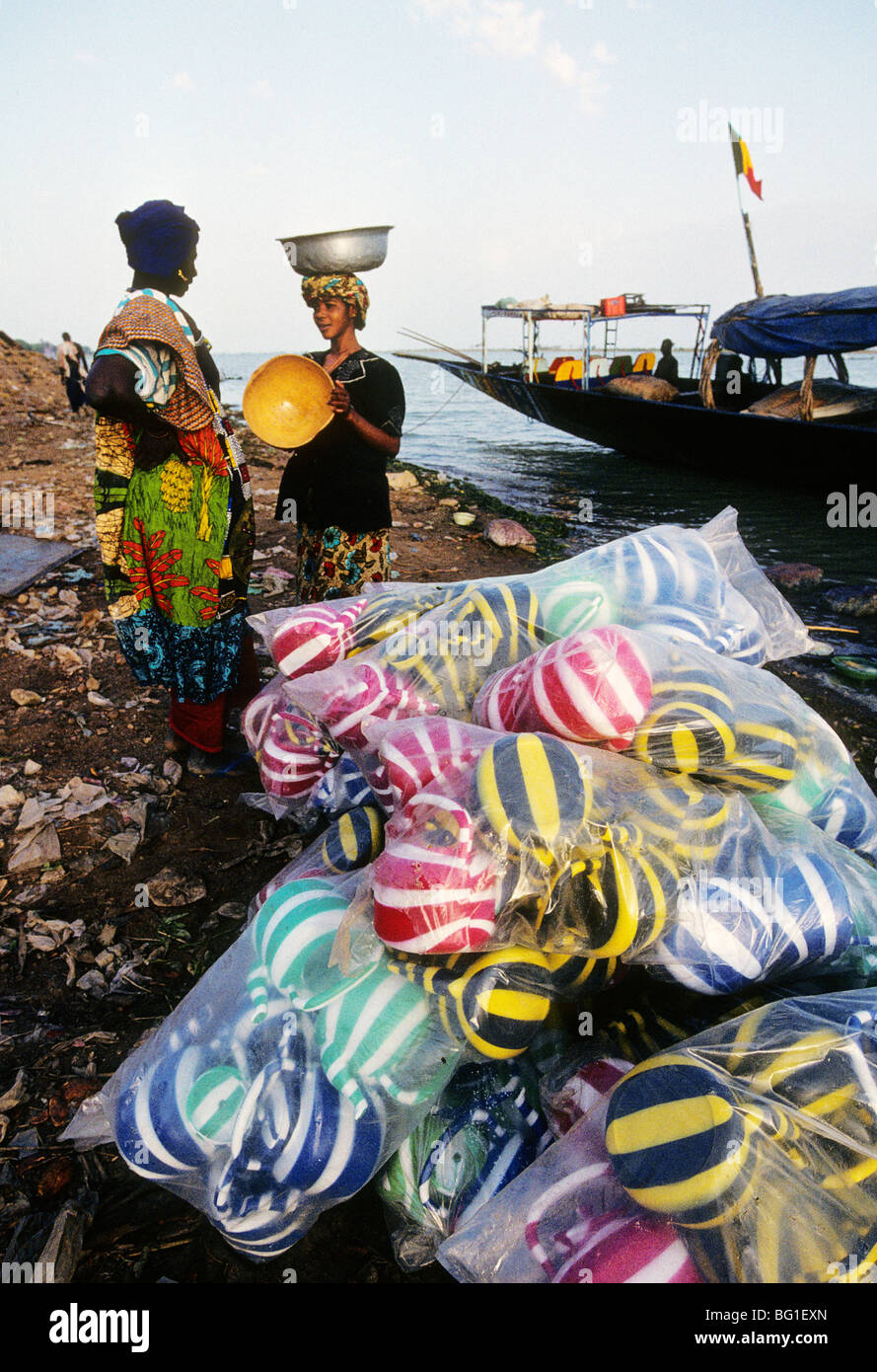 Plastic pots and bowls have just been unloaded from a large pirogue in ...