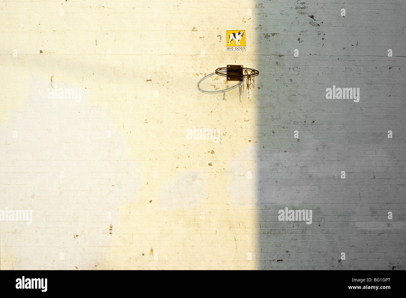 An old basketball rim without a net hangs beneath the Big Dogs logo in ...