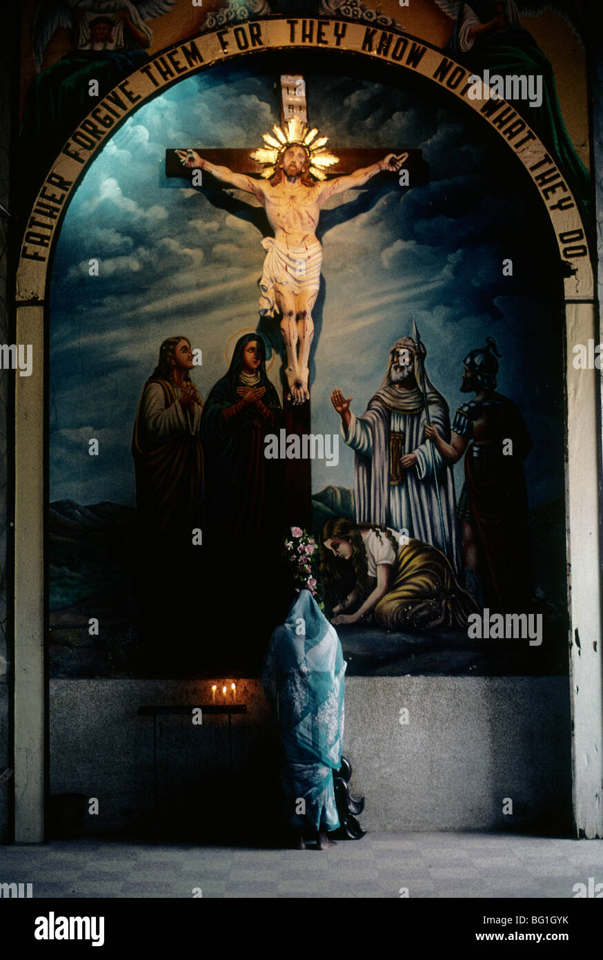 A woman prays worships in the Santa Cruz Basilica, a Roman Catholic ...