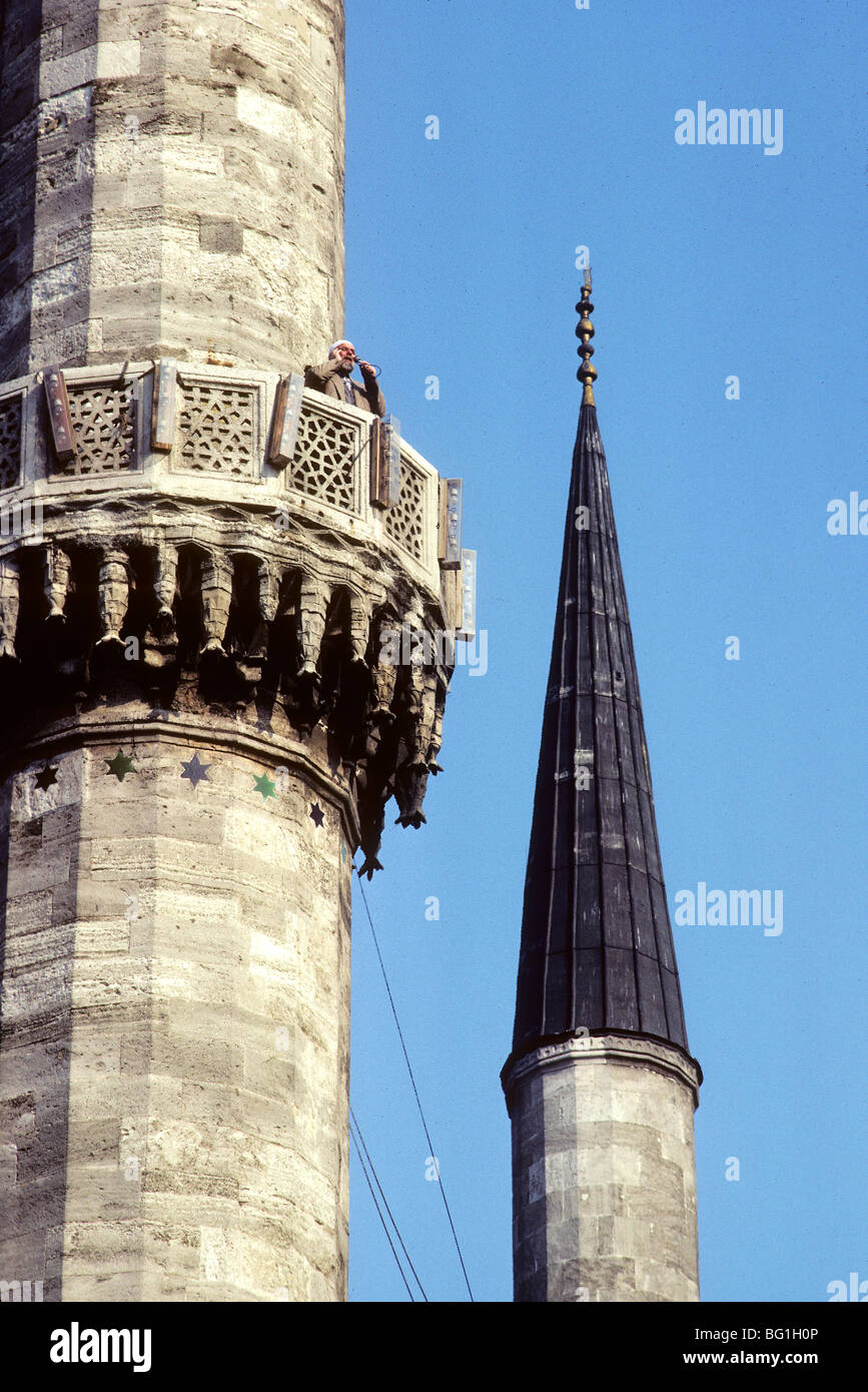 A muezzin, a man appointed to call to prayer, makes the middle of the ...