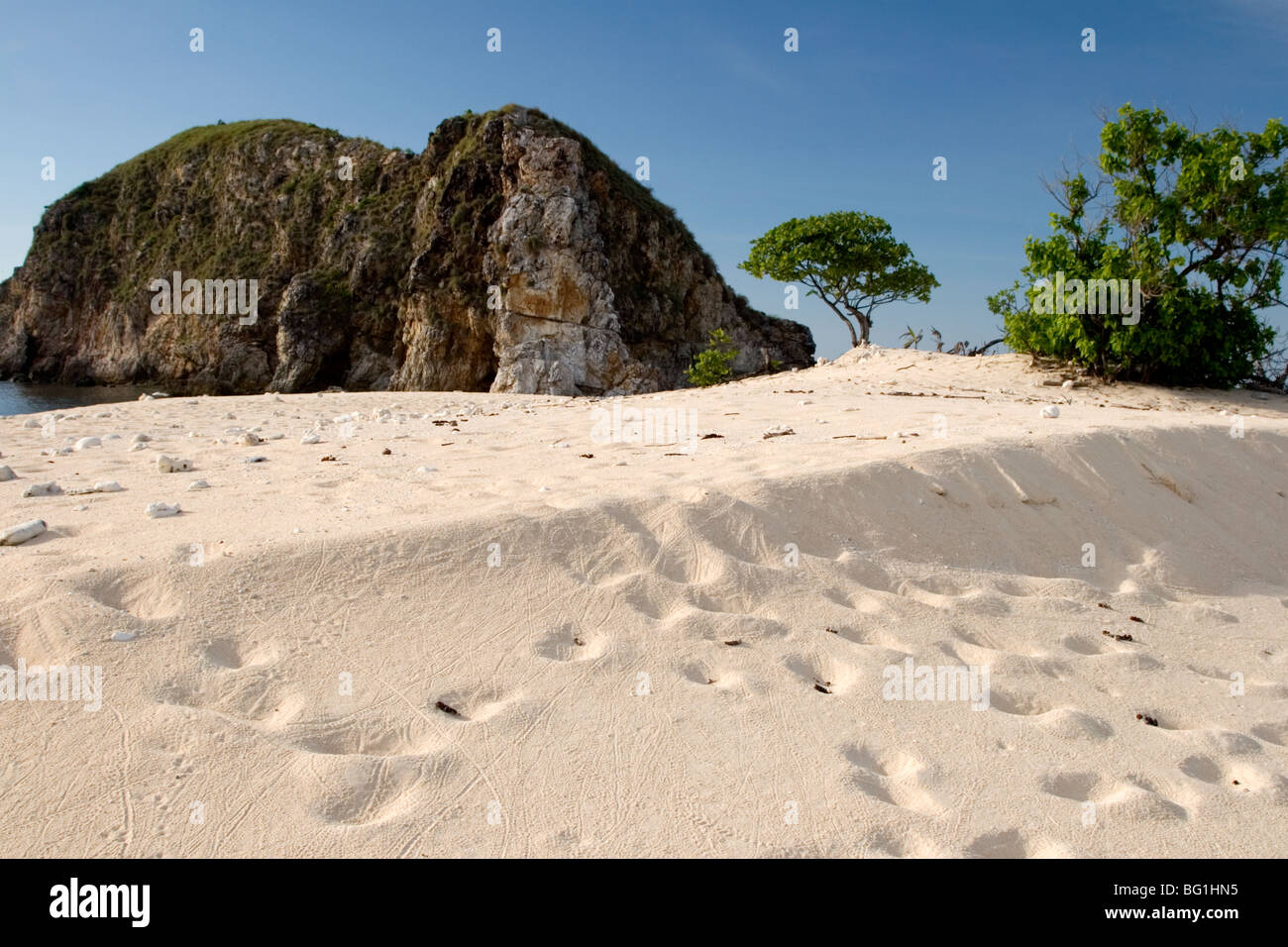 An uninhabited small isle with a long sandy beach in Maricaban Bay in ...