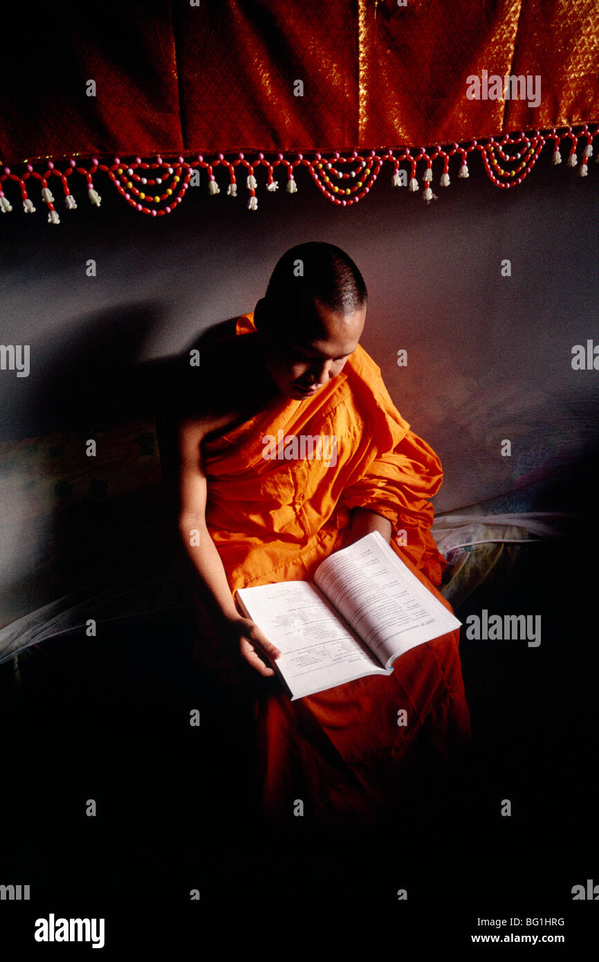 A Buddhist monk studies Buddhist philosophy early in the morning. He as ...