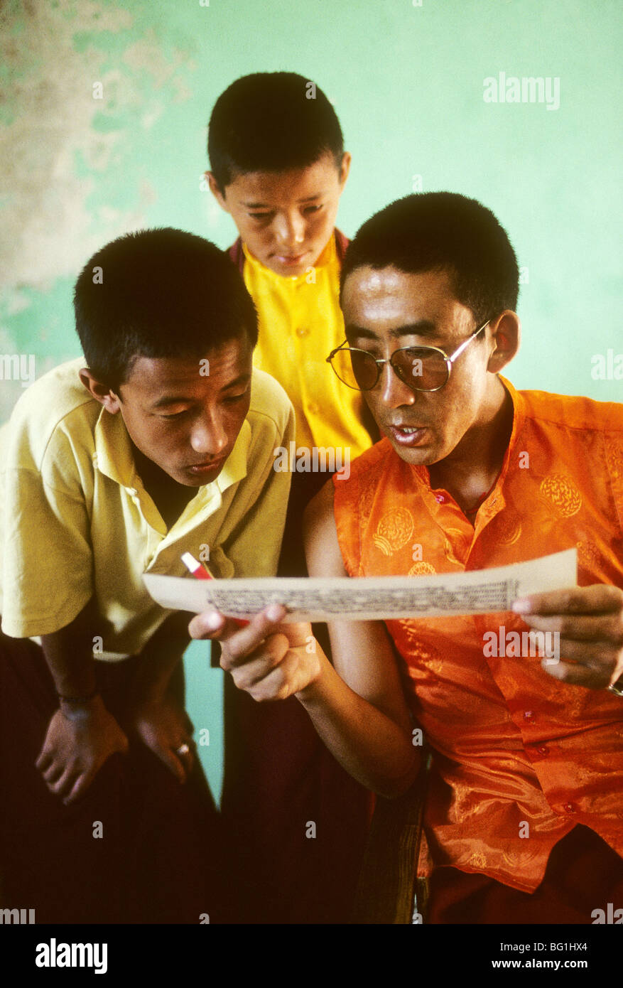 Young Tibetan monk students study Buddhism with their teacher in a ...
