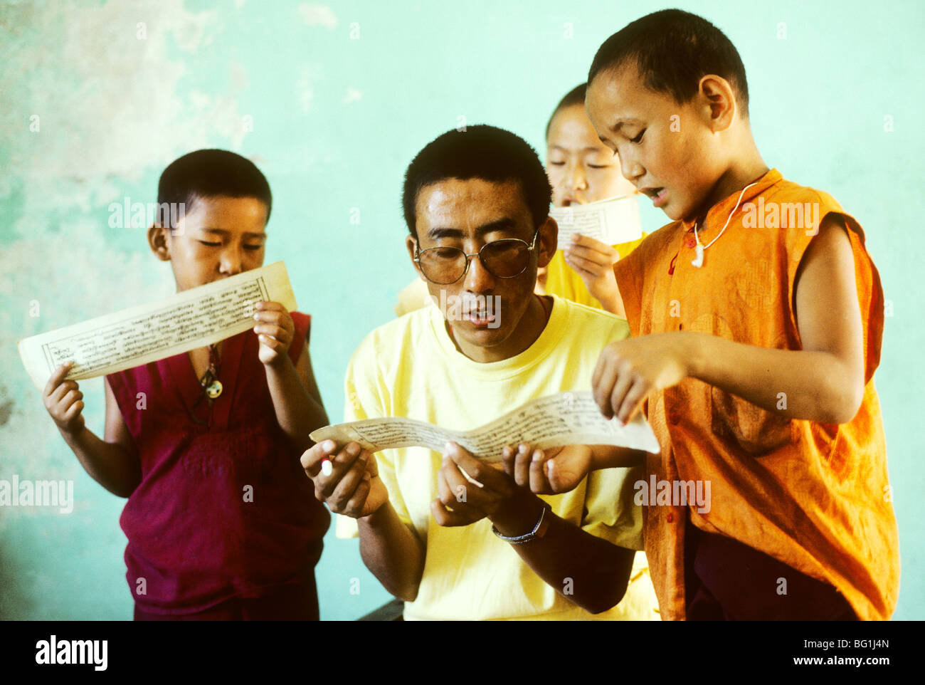 Young Tibetan monk students study Buddhism with their teacher in a ...