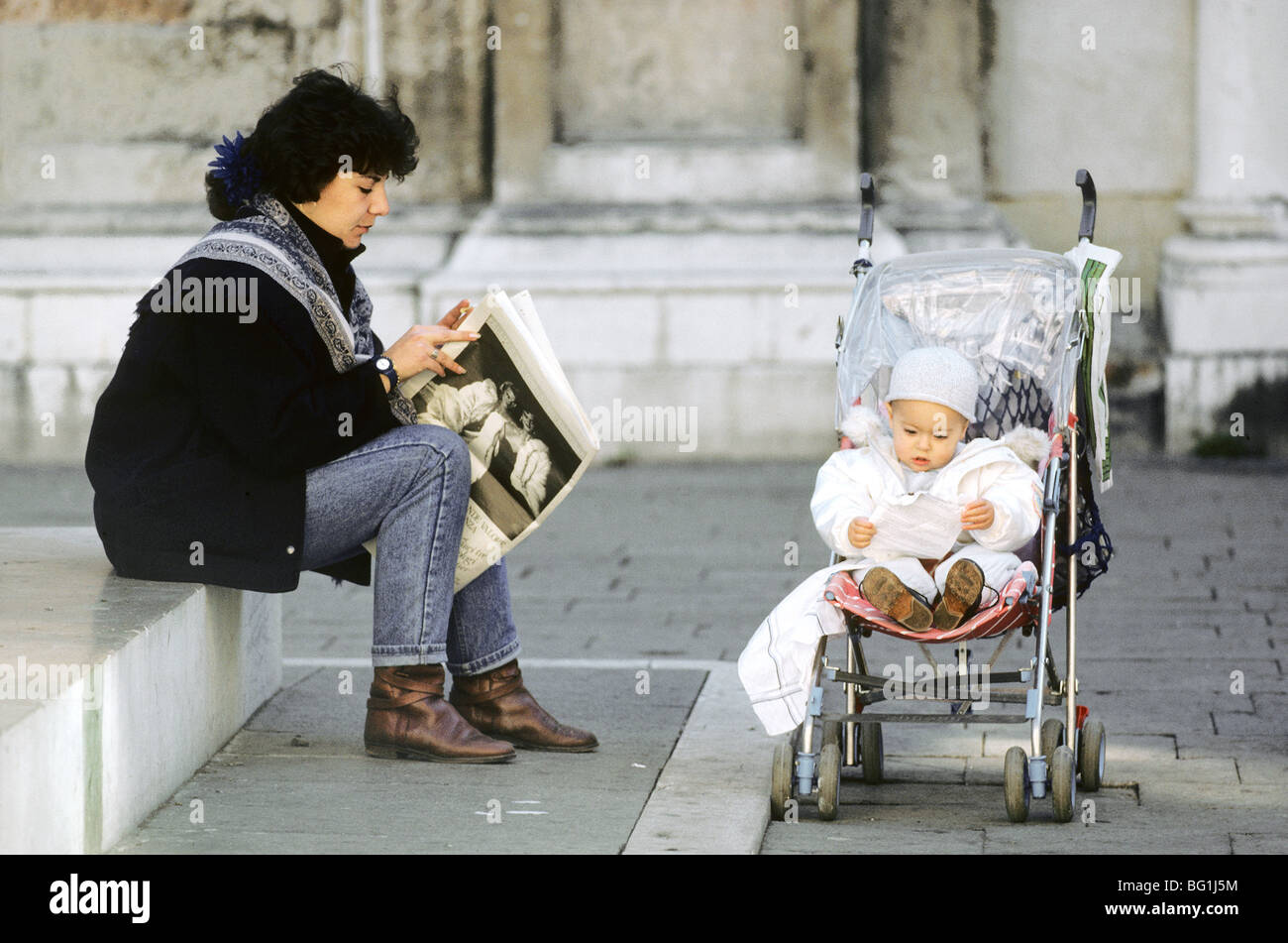A mother reads the newspaper and her baby reads a letter in Venice ...