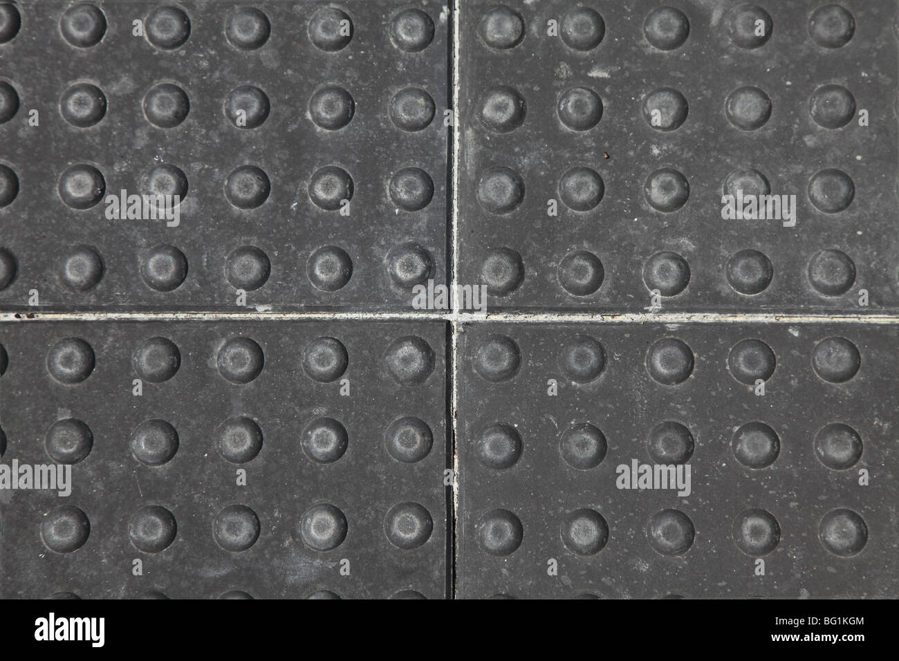 Raised and textured outdoor concrete tiles Stock Photo - Alamy