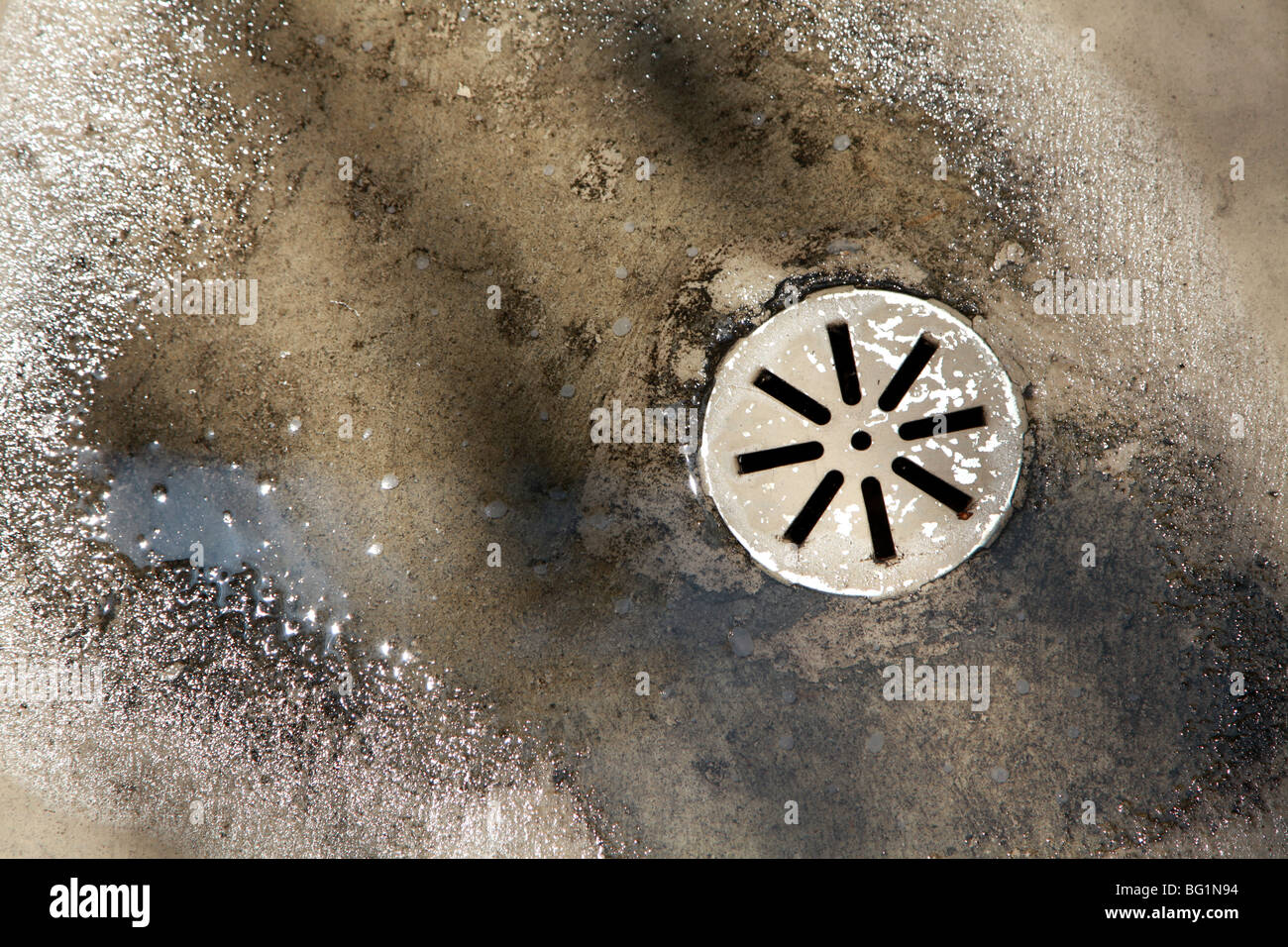 Water puddles around a drain after a heavy rain Stock Photo - Alamy