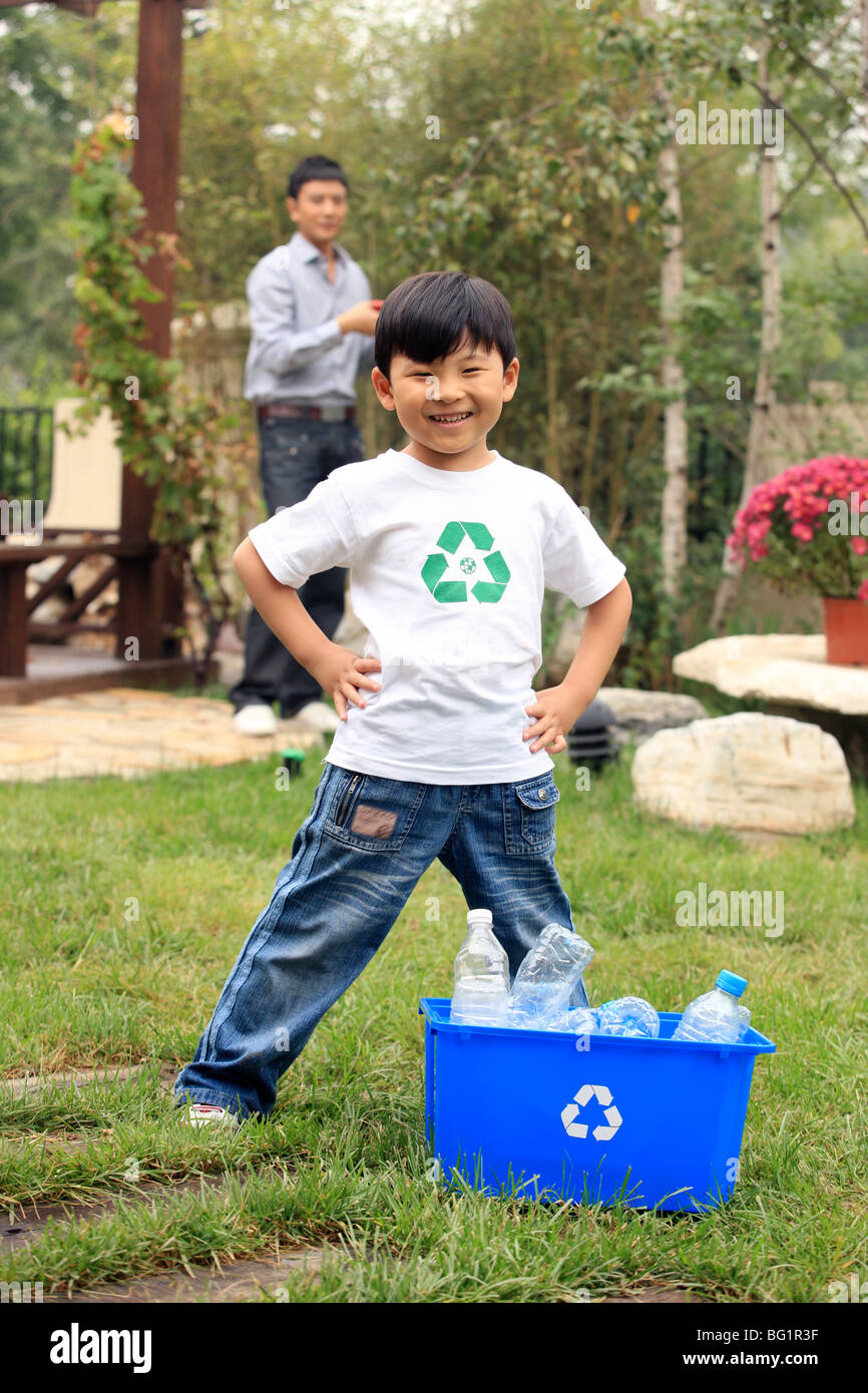 Two boys carrying recycling container hi-res stock photography and ...