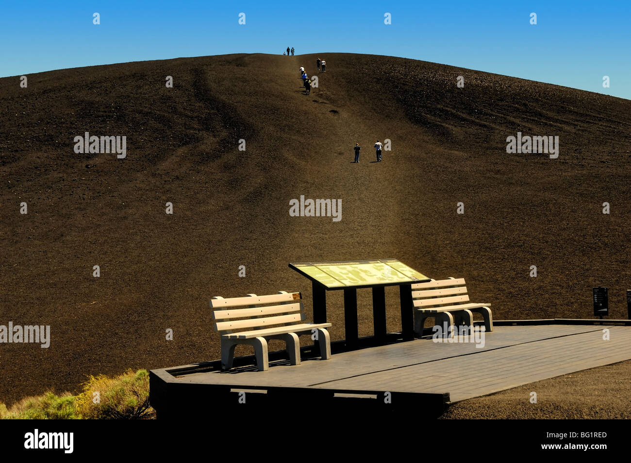 Visitors climbing up Inferno Crater, an extinct volcanic cone at ...