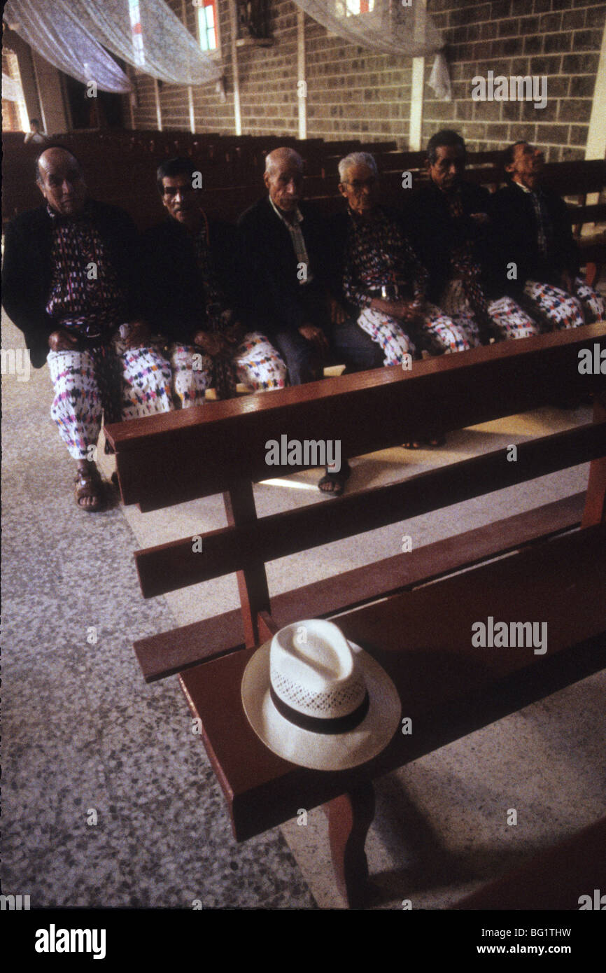 In their traditional dress men sit in a pew and prepare to worship in ...