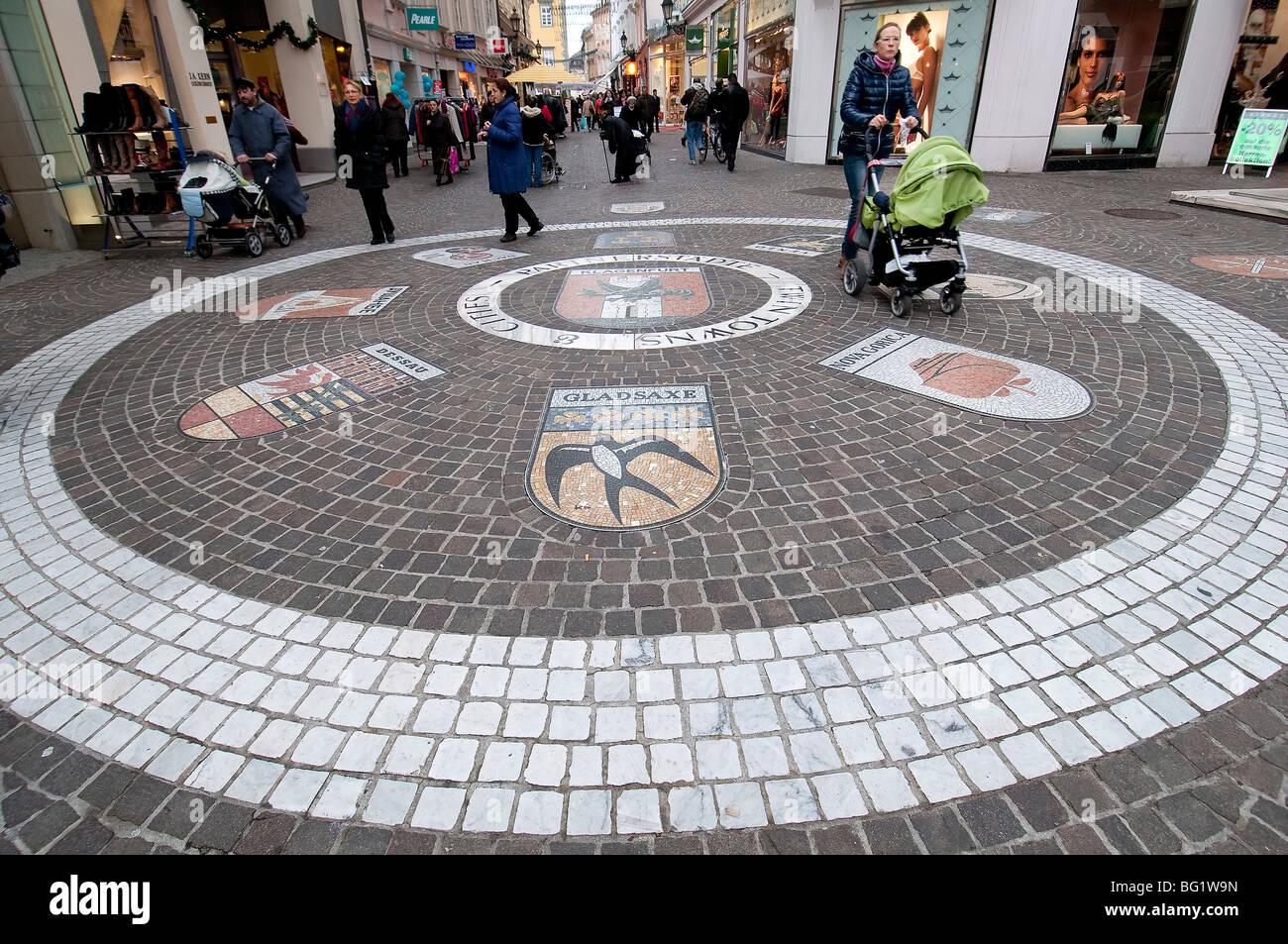 the city coats of arms in the pavement of the main street Stock Photo ...