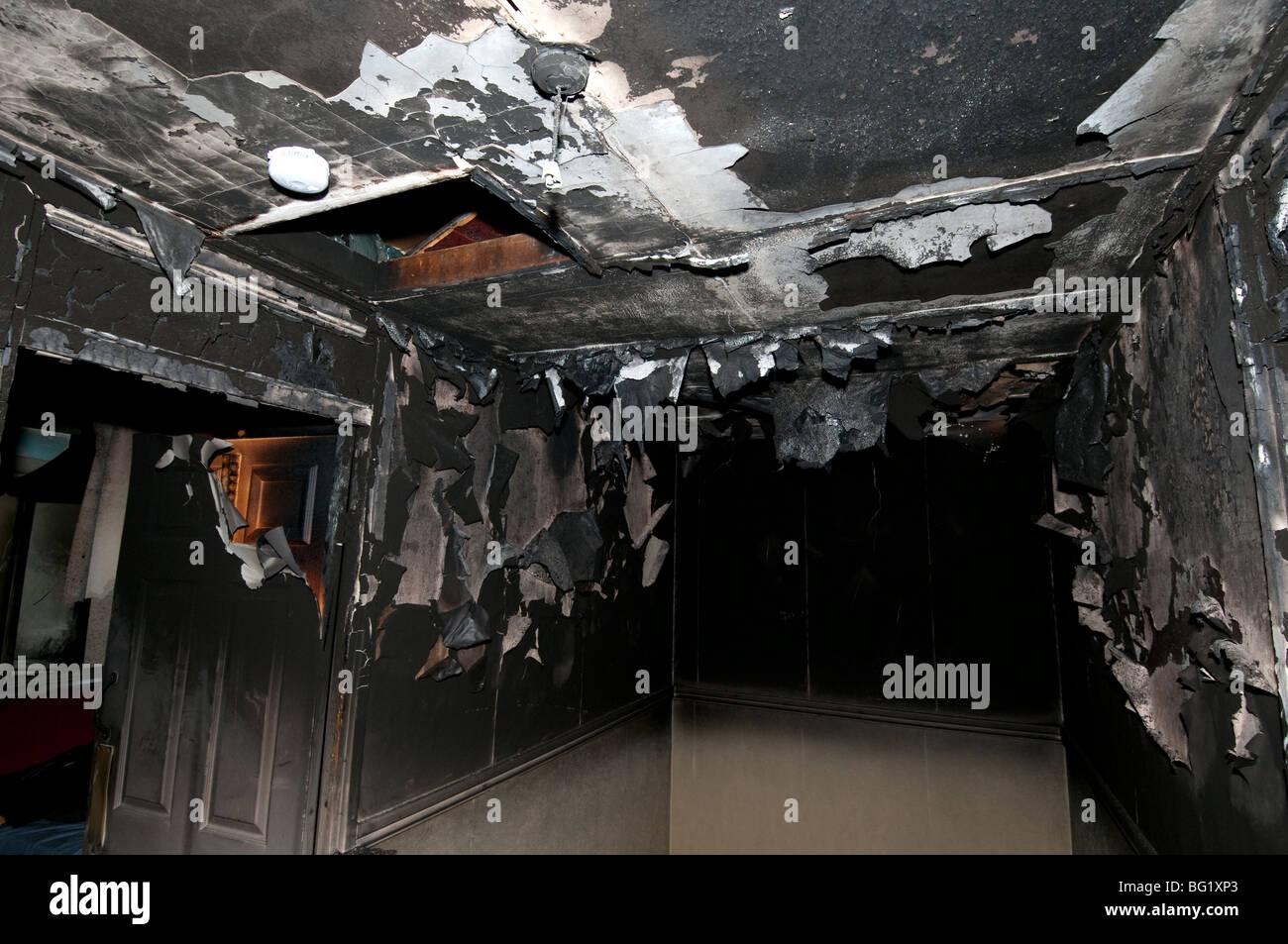 Burnt landing ceiling following bedroom house fire Stock Photo - Alamy